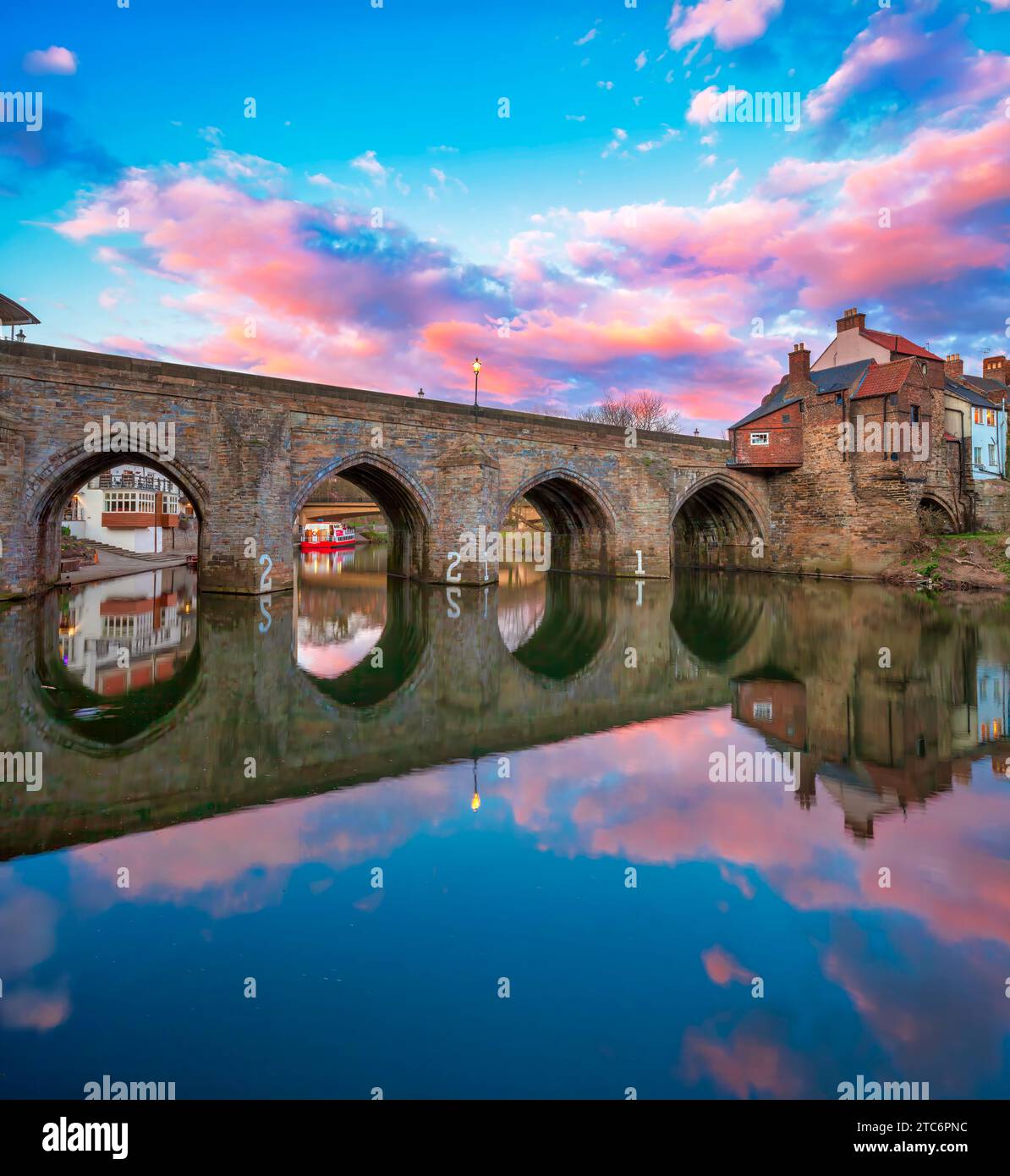 A view at sunset of Elvet Bridge in the City of Durham reflected in the ...