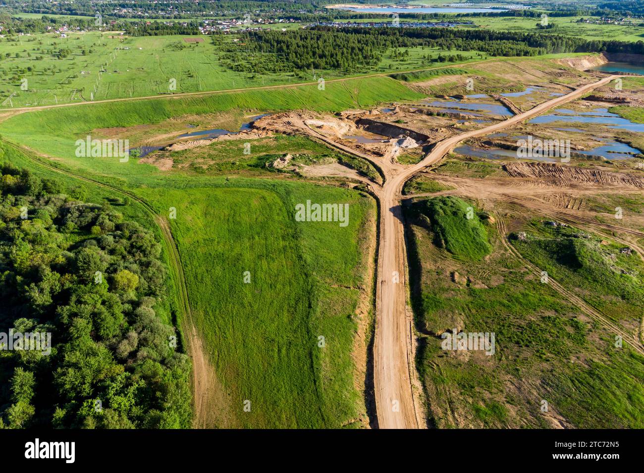 Drone view of the territory of an overgrown quarry with road ...
