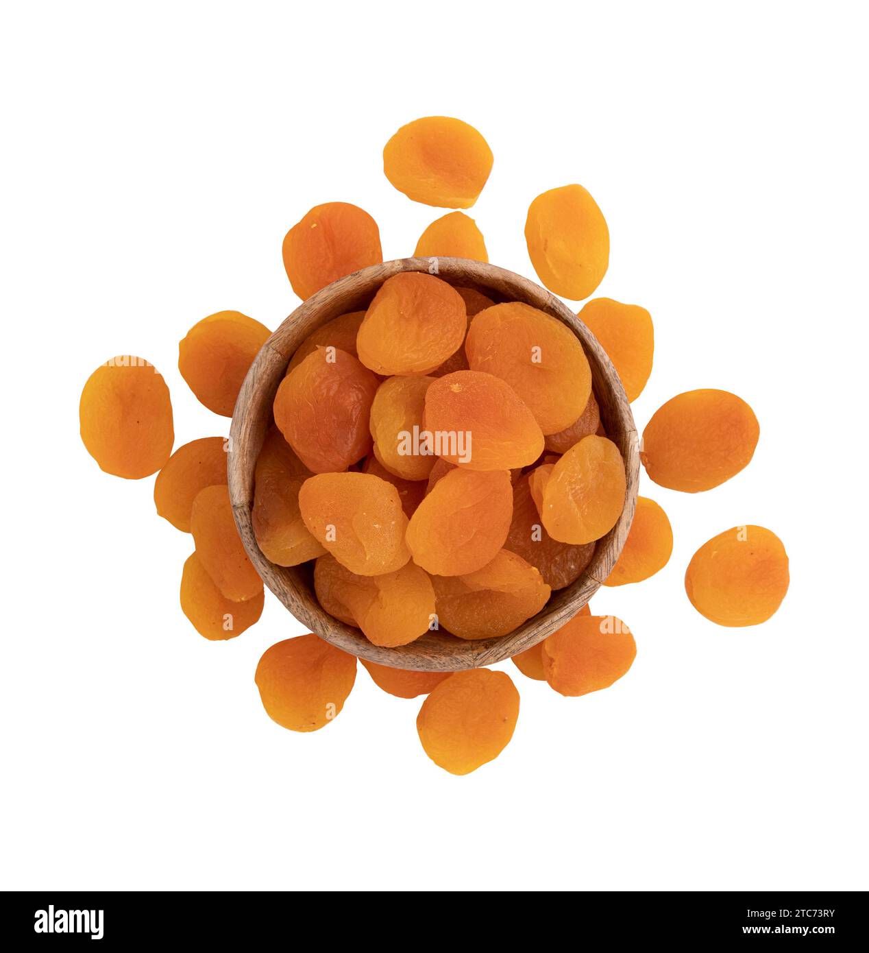 dried apricots in wooden bowl isolated on white background with ...
