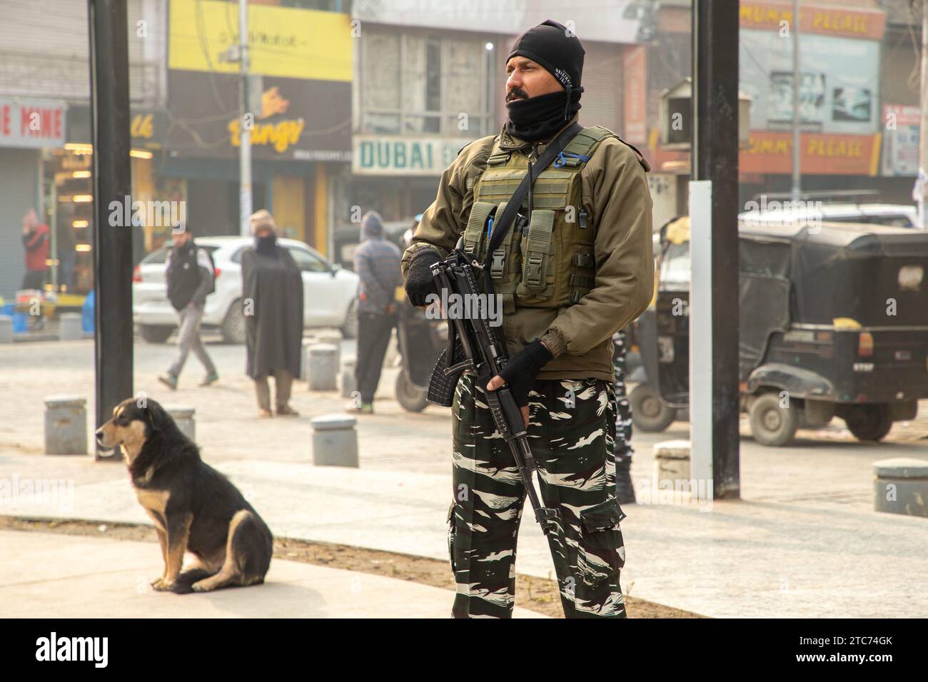 Indian paramilitary personnel stands guard along a road in Srinagar ...