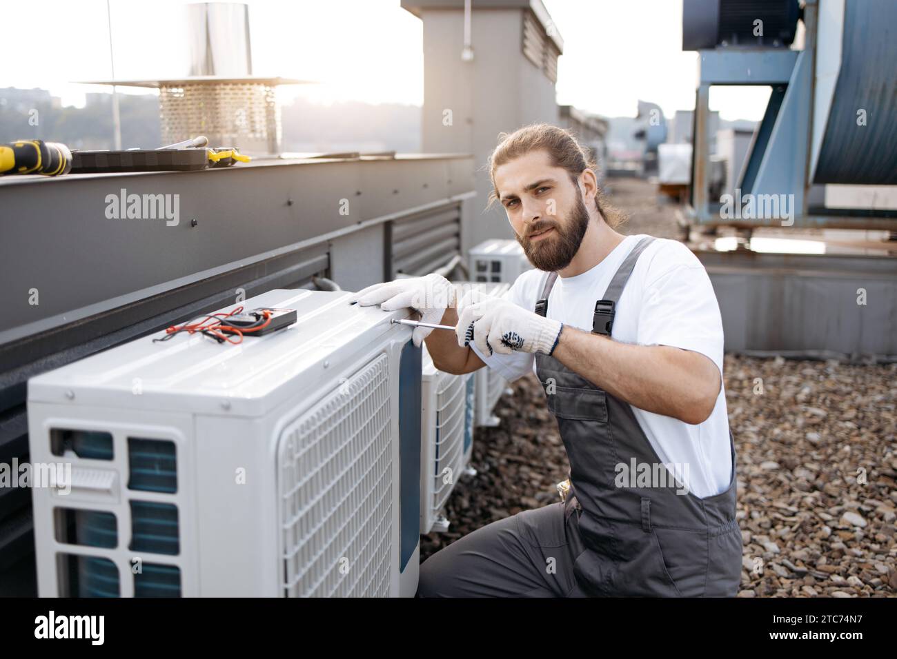 Man builder repairing conditioner using screwdriver outdoor Stock Photo ...