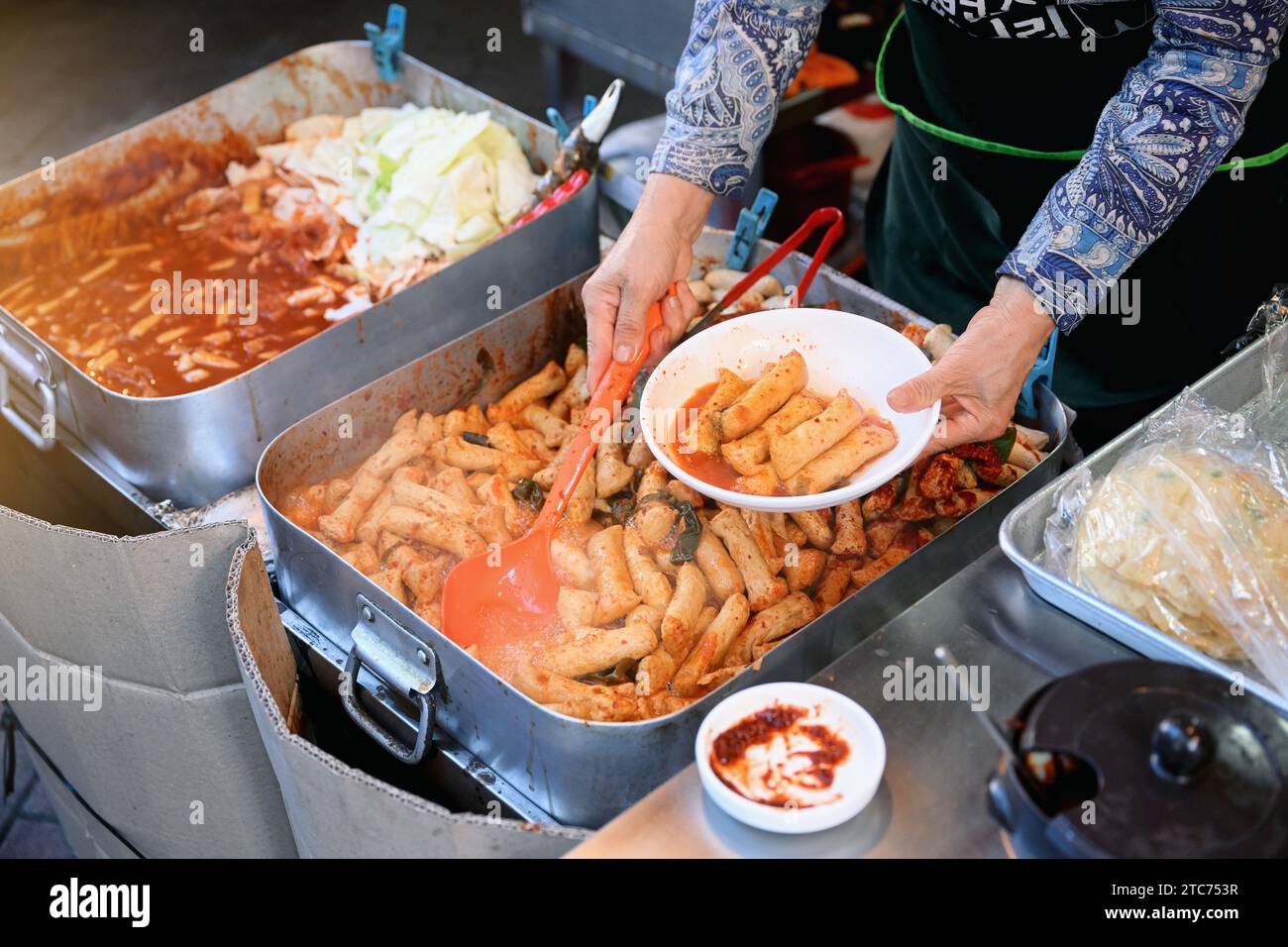 Cooking fish cakes in a shop at a street food stall in South Korea ...