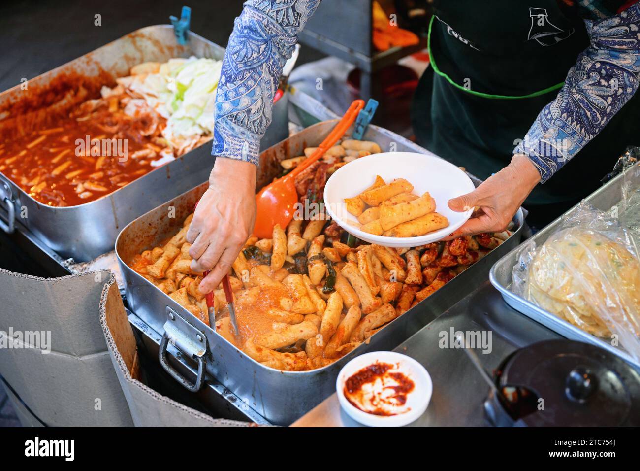 Cooking fish cakes in a shop at a street food stall in South Korea ...