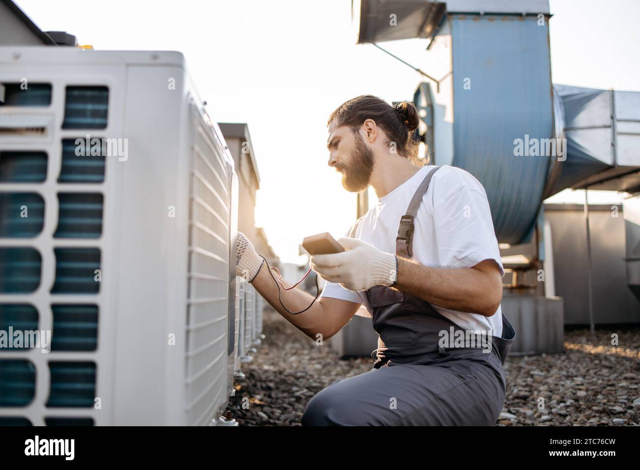 Man builder applying measuring device to conditioner outdoor Stock ...
