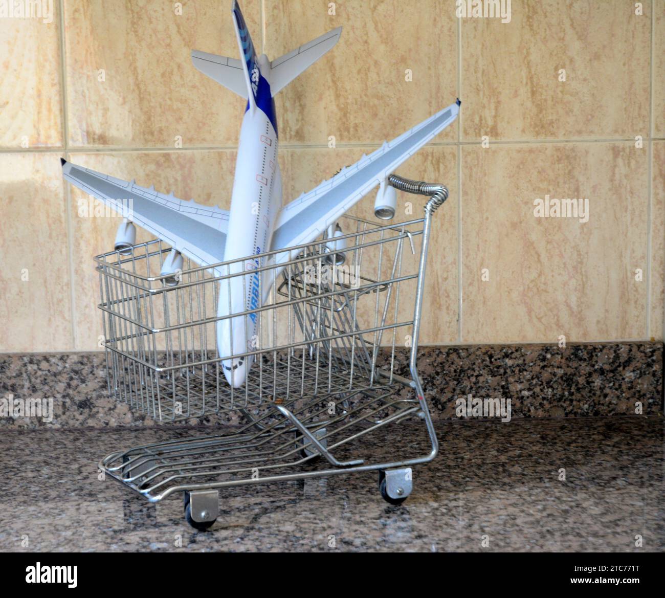 Commercial plane inside a supermarket cart. Conceptual photo of air ...