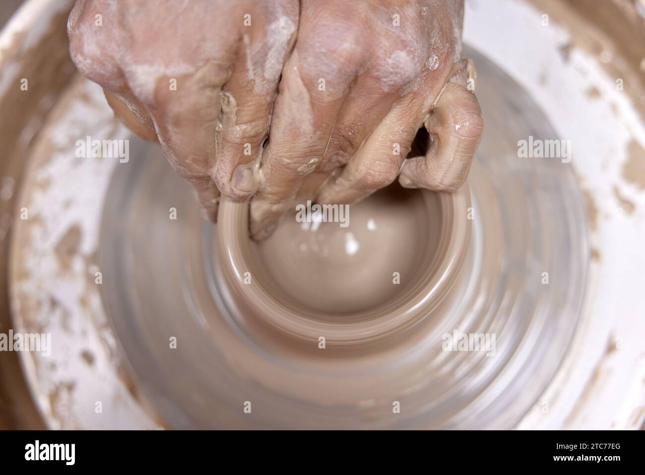 male hands making ceramic cup on pottery wheel, Close-up, top view ...