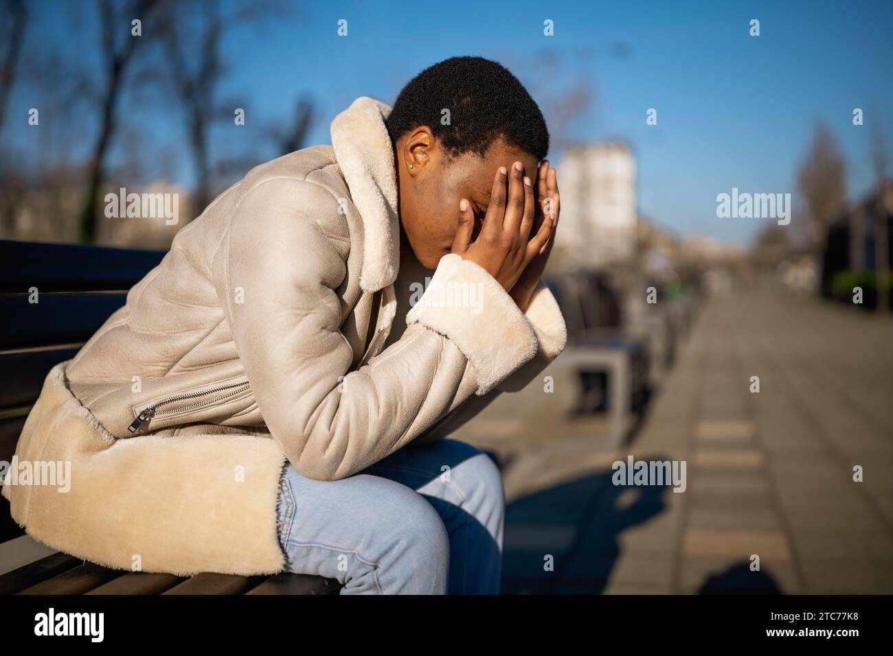 Outdoor portrait of depressed african-american woman on sunny day. She ...