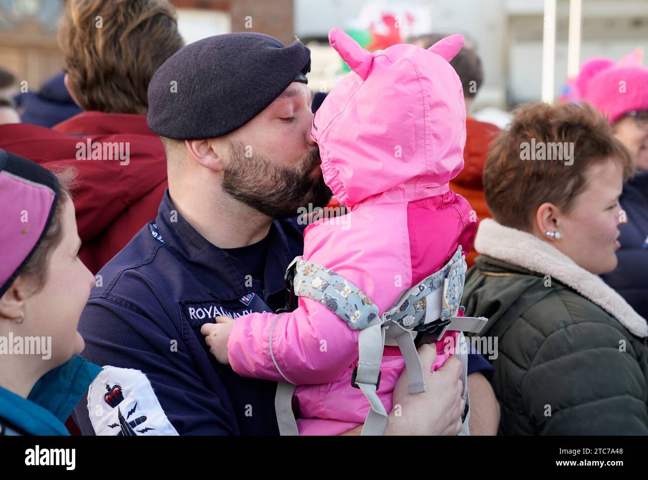 Petty Officer Nicholas Baker holds his daughter Amelia-Rose after the ...