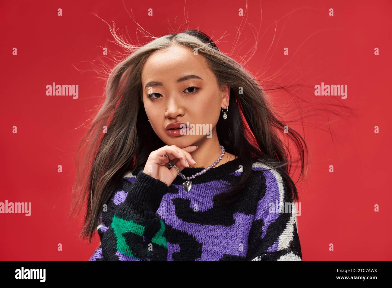 wind blowing at face of attractive young asian woman with dyed hair in ...