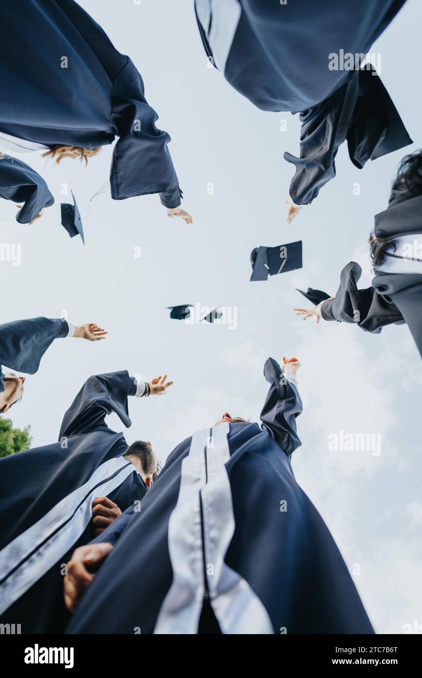 Happy students congratulating each other after successful graduation ...