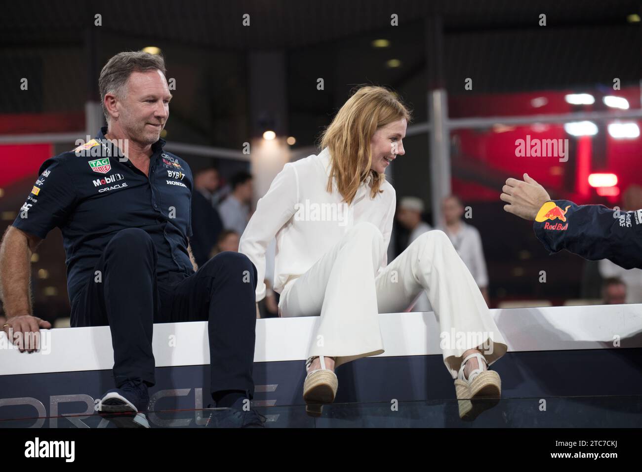 Geri Halliwell and Christian Horner climbing down from side of track to ...