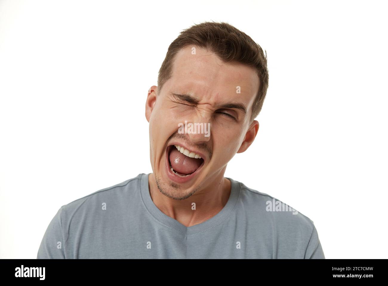 portrait of young happy man winking looking at the camera on white ...
