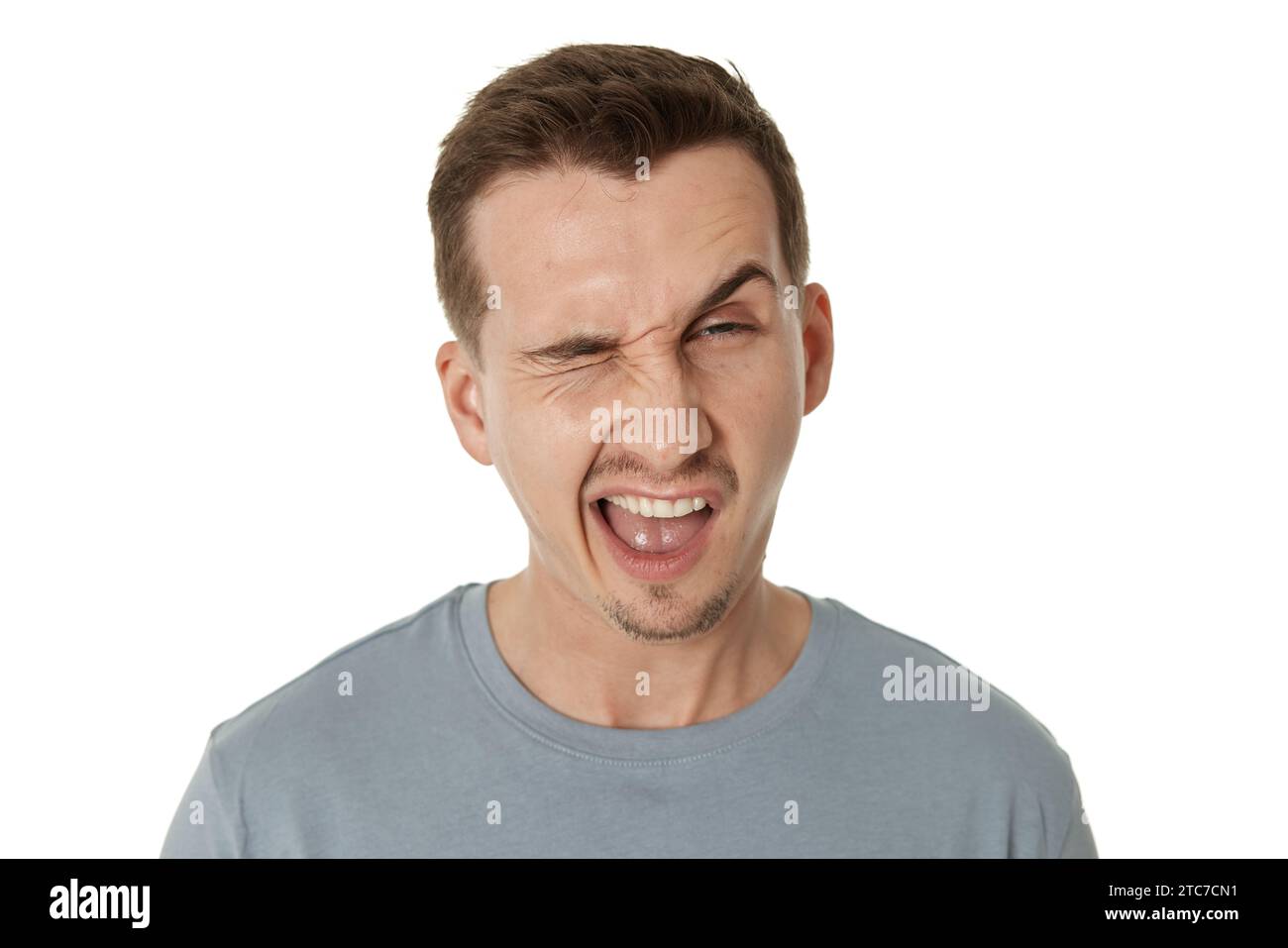 portrait of young happy man winking looking at the camera on white ...