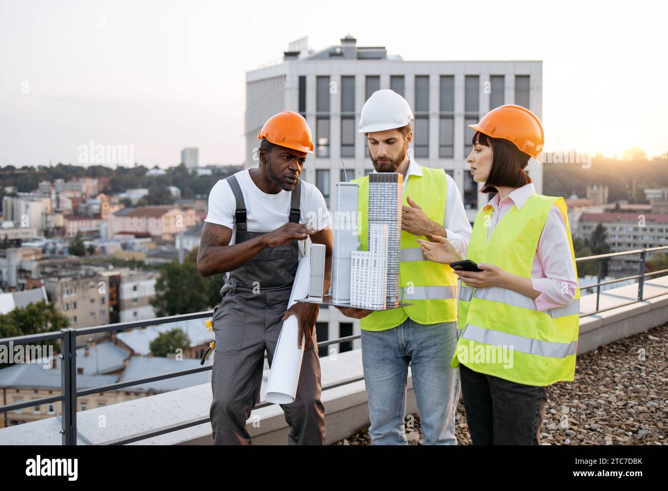 Civil engineers discussing common project together on roof Stock Photo ...