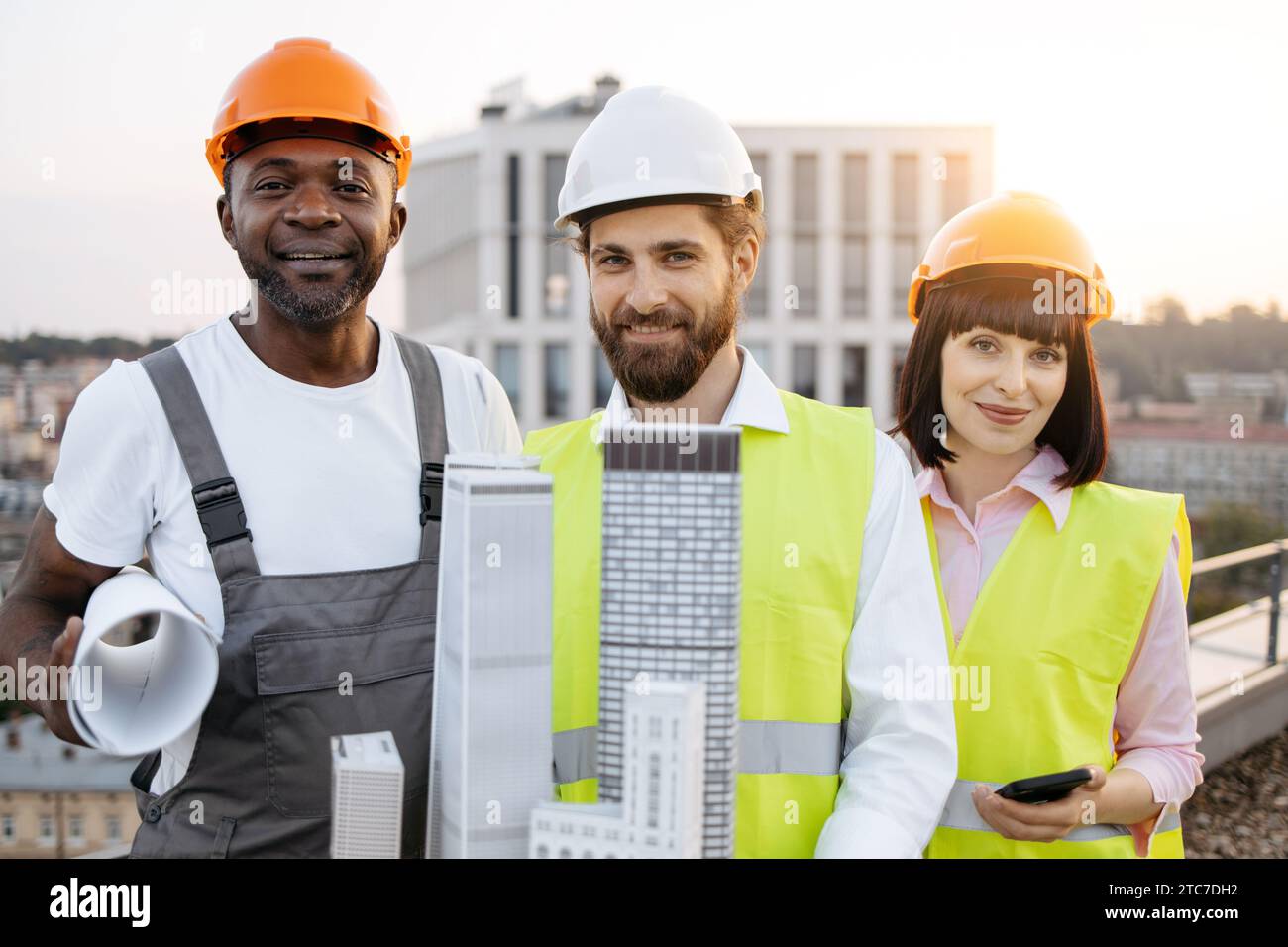 Multicultural designers with equipment posing on rooftop Stock Photo ...