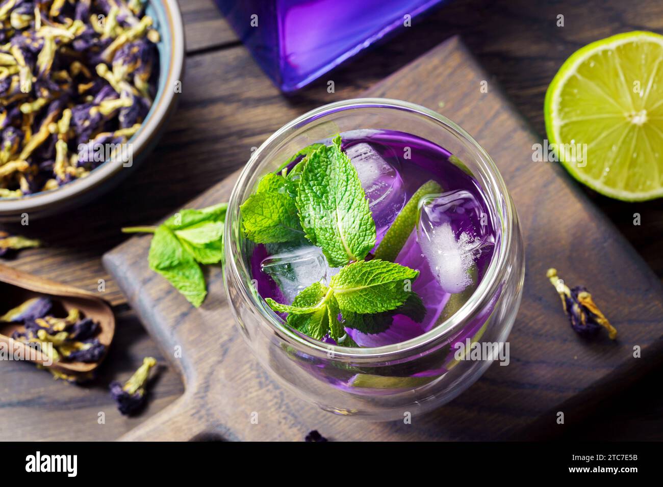 Refreshing summer drink, iced organic blue and violet butterfly pea ...