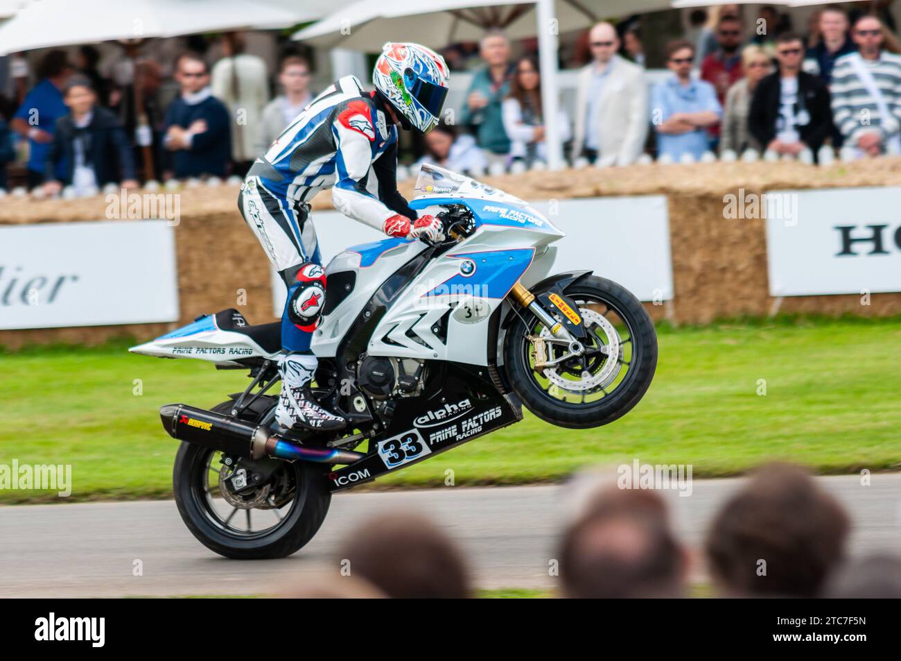 Troy Corser, pulling a wheelie riding a BMW S1000RR motorcycle at the ...
