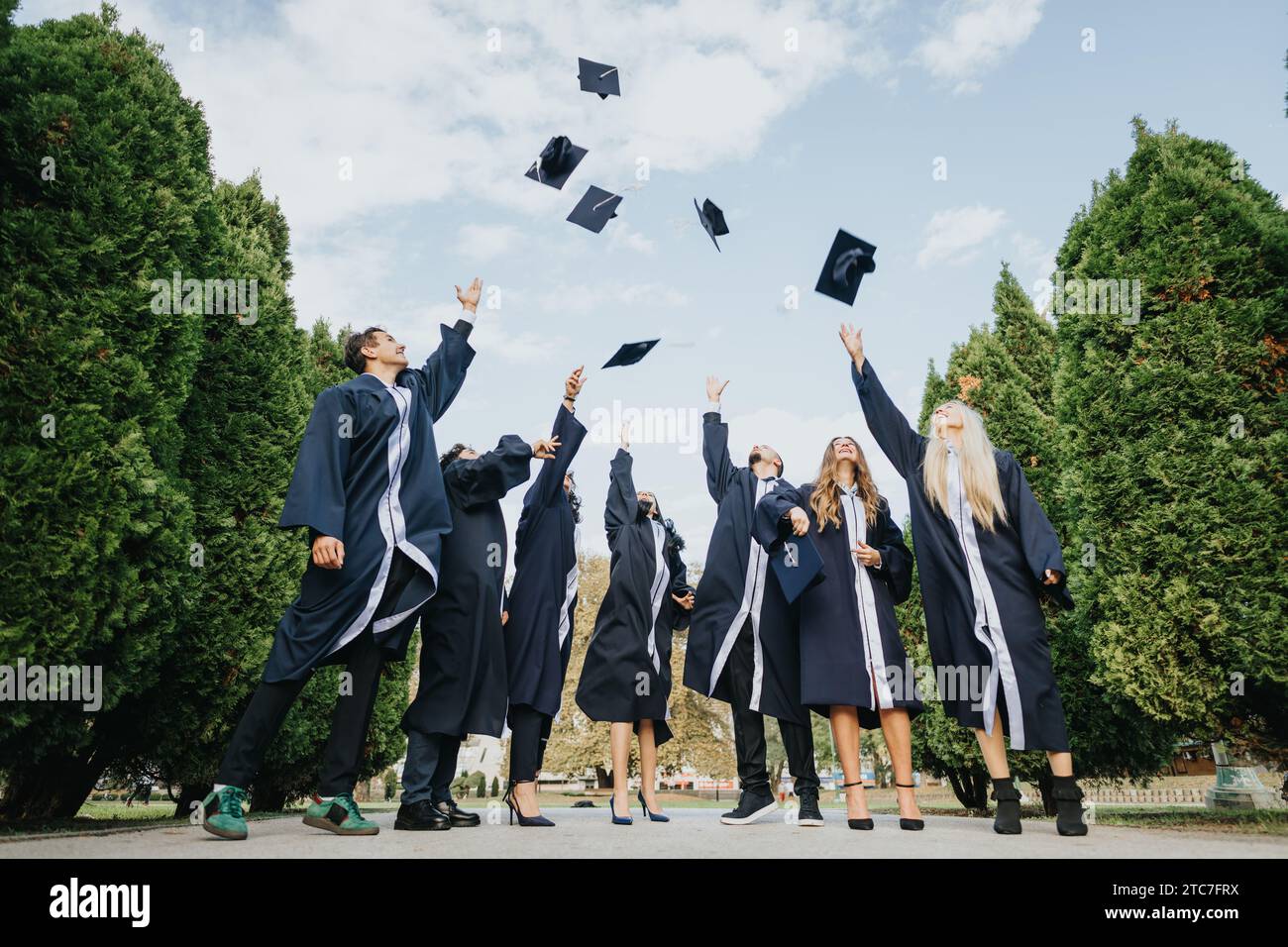 University students throwing their caps in the air, creating beautiful ...