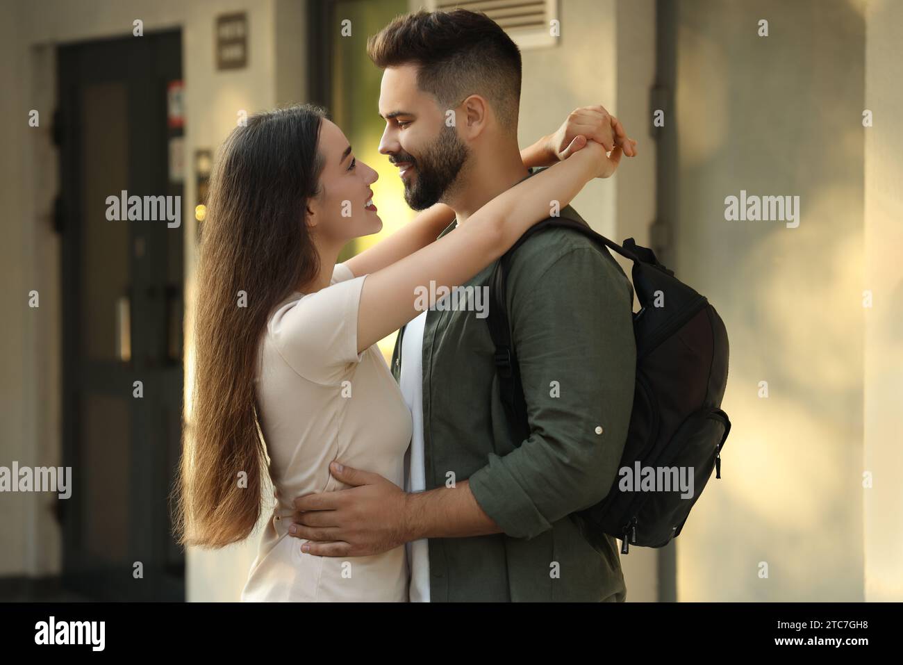 Long-distance relationship. Man with backpack hugging with his ...