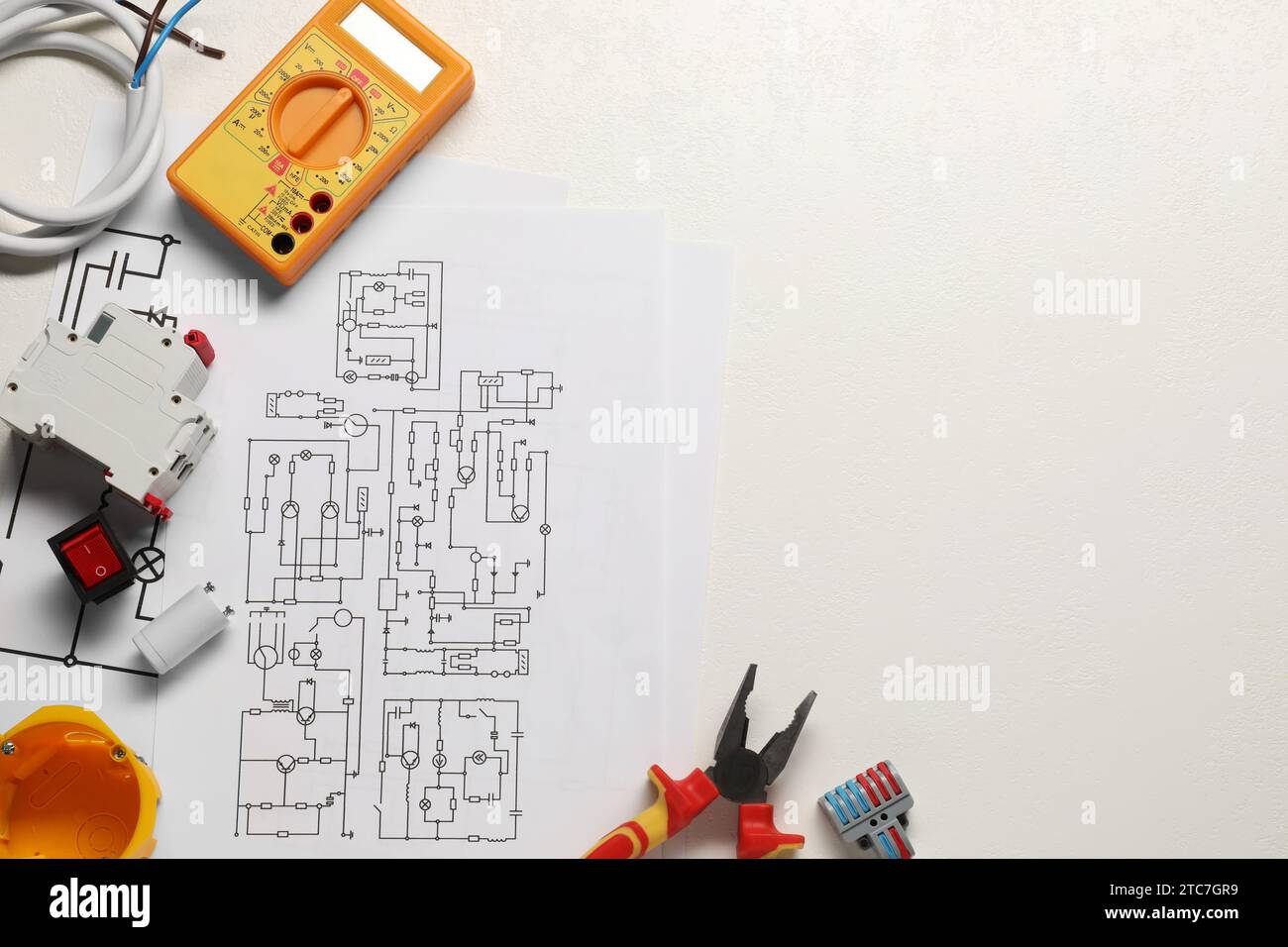 Flat lay composition with wiring diagrams and digital multimeter on ...