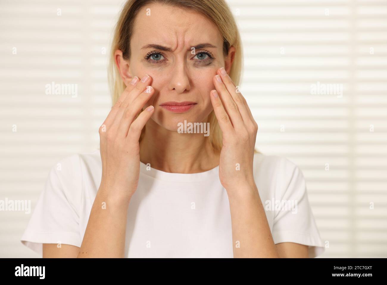 Sad woman with smeared mascara crying indoors Stock Photo - Alamy