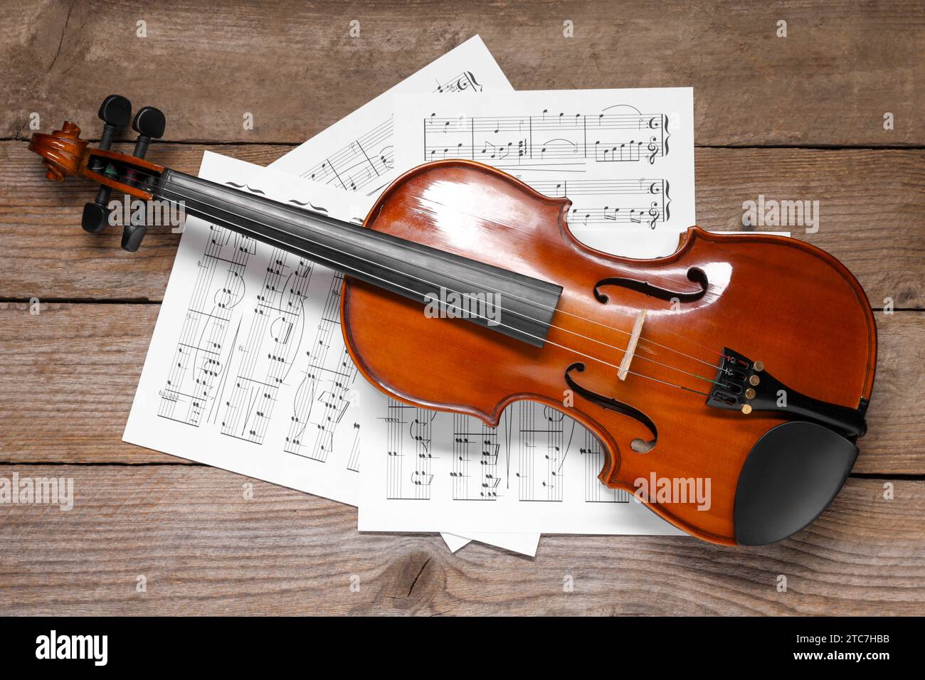 Violin and music sheets on wooden table, top view Stock Photo - Alamy