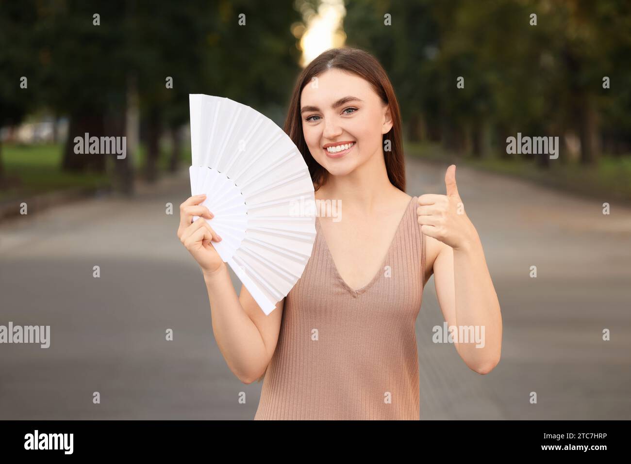 Woman holding fan in hand hi-res stock photography and images - Alamy