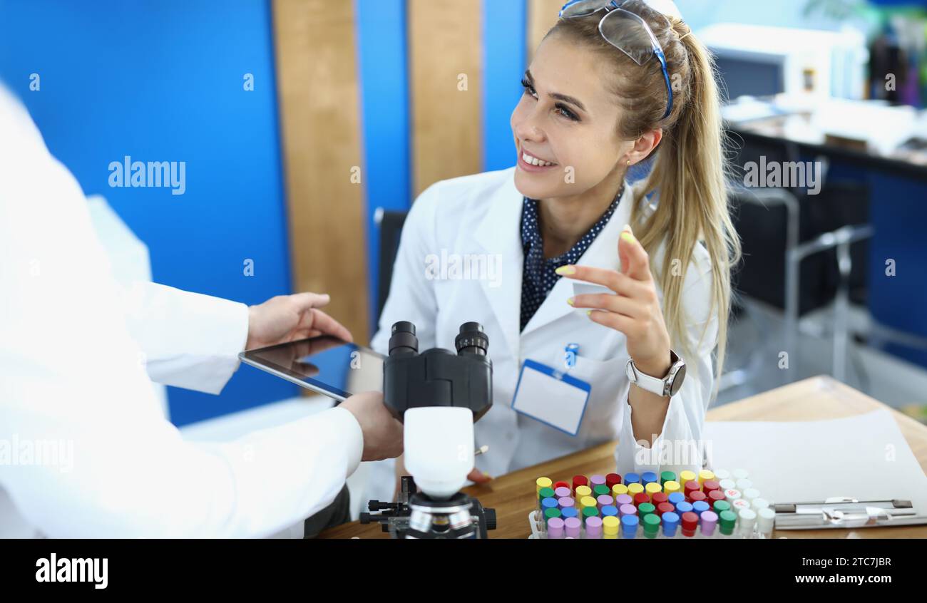 Physician scientists colleagues smile and communicate in laboratory ...