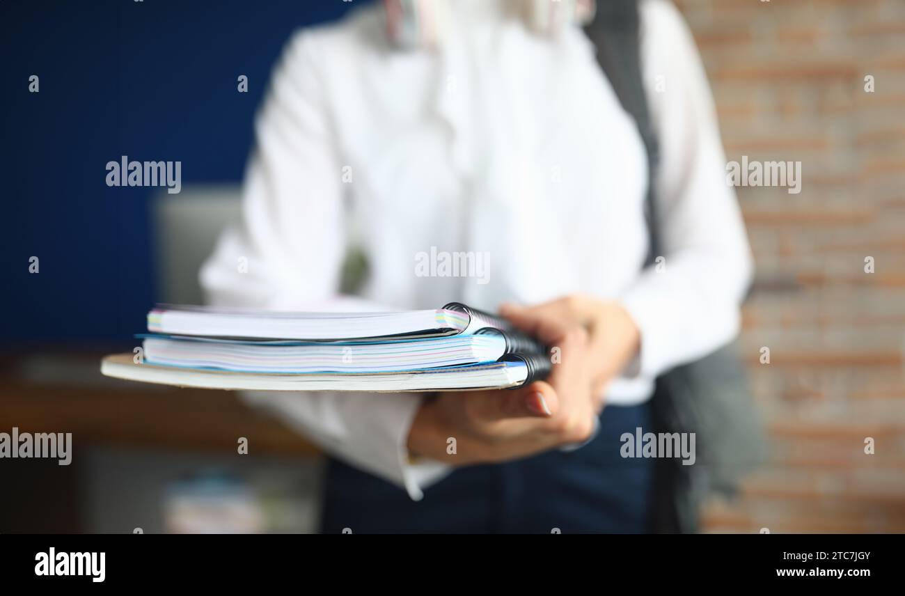 Female student holds folder and notebook in hands for studying Stock ...
