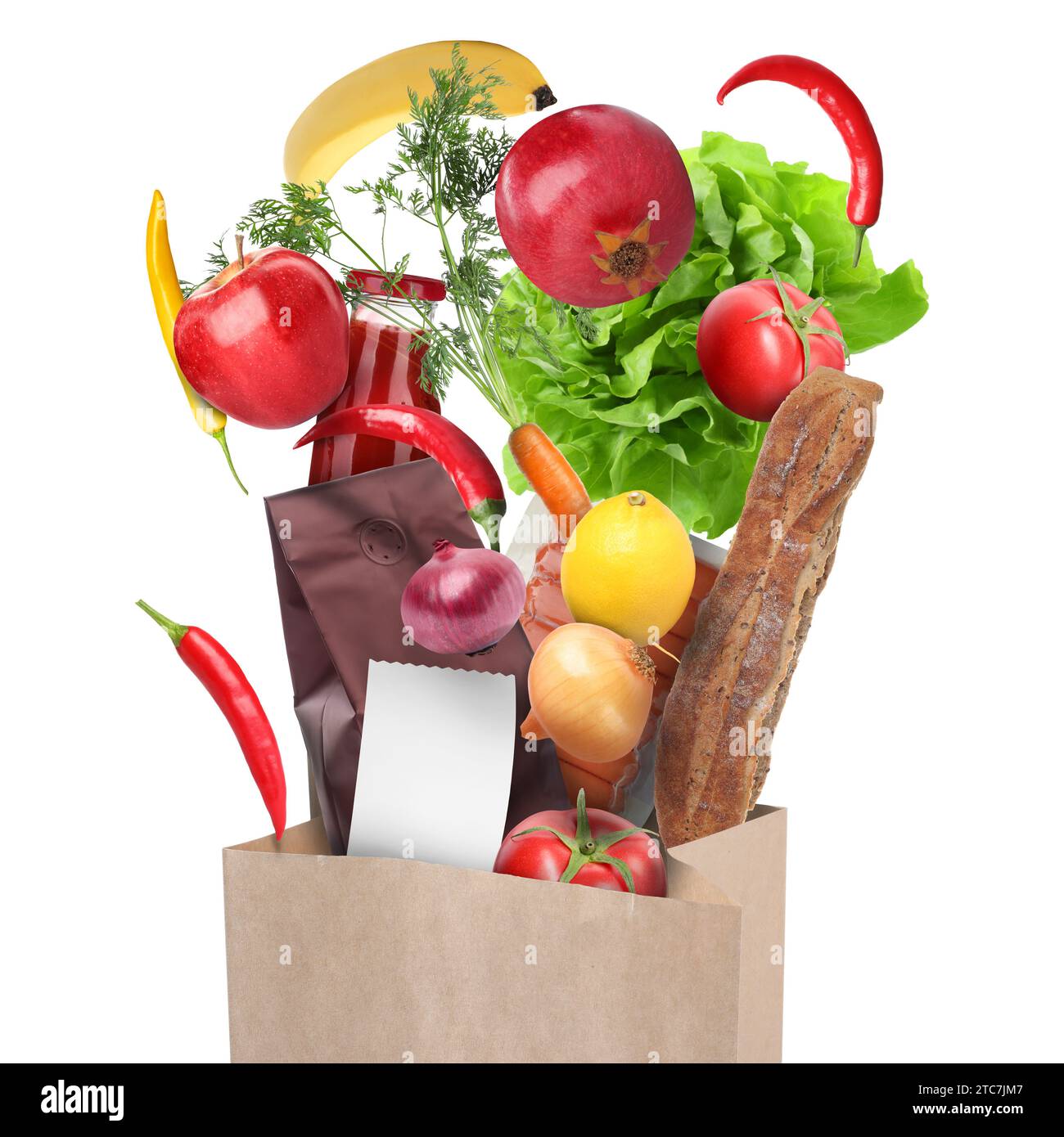 Different food products falling into paper bag on white background ...