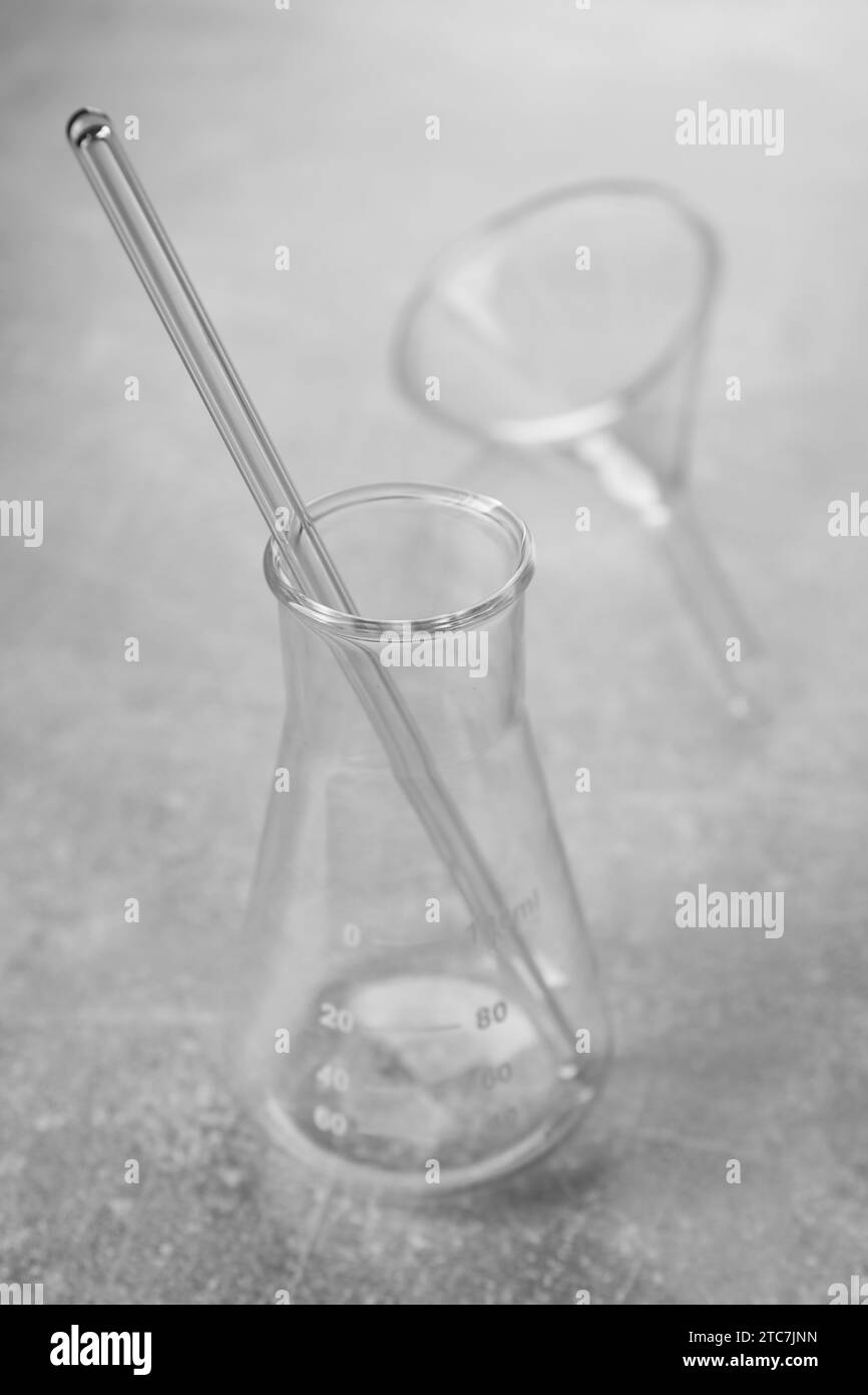 Laboratory flask with pipette on grey table, closeup Stock Photo - Alamy