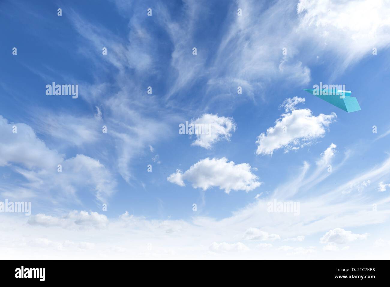 Light blue paper plane flying in sky with clouds with clouds Stock ...