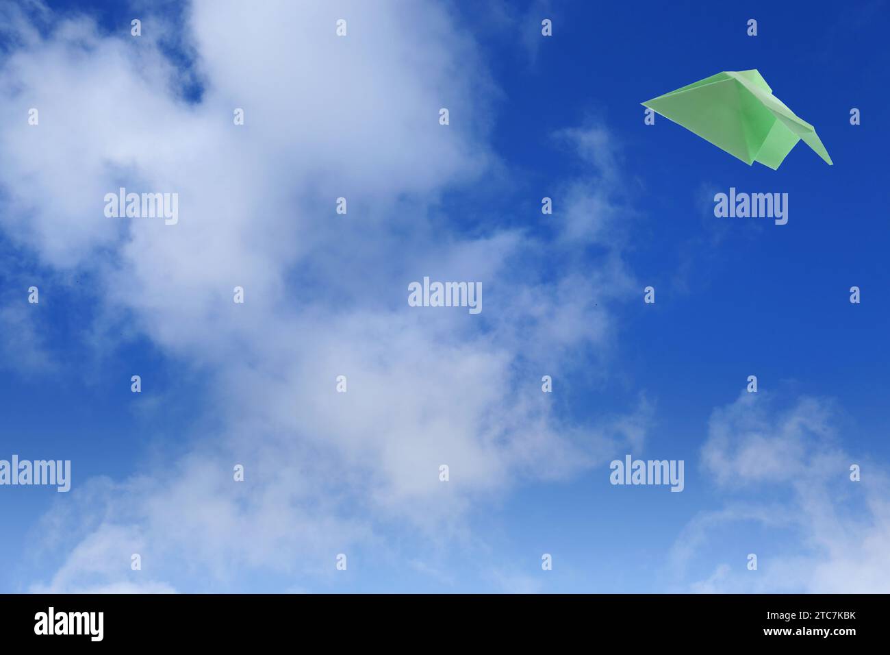 Green paper plane flying in blue sky with clouds Stock Photo - Alamy