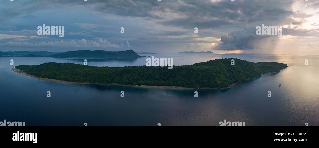 Rain clouds drift across the scenic and colorful Indonesian seascape ...