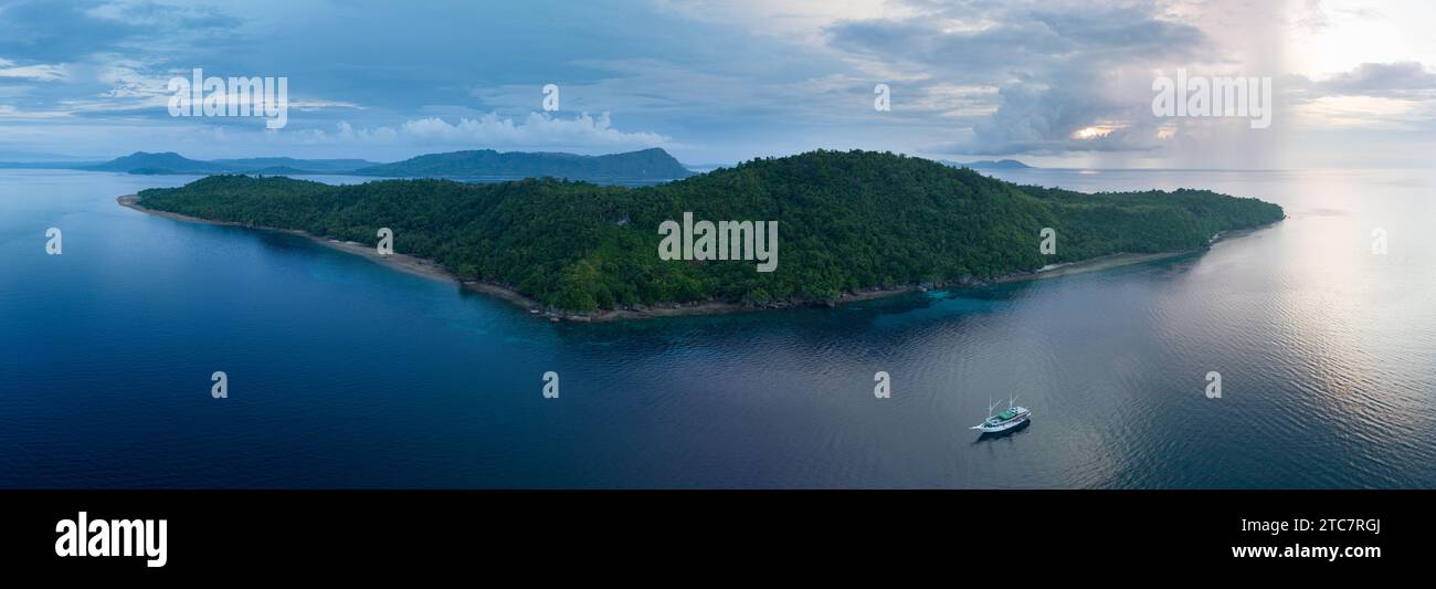 Rain clouds drift across the scenic and colorful Indonesian seascape ...