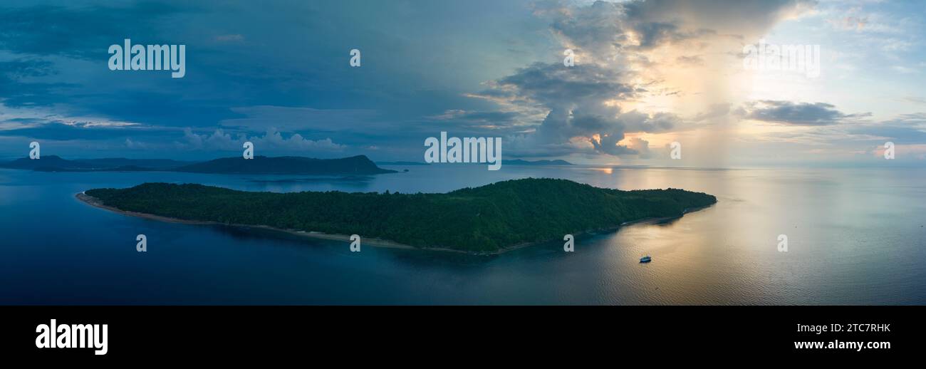Rain clouds drift across the scenic and colorful Indonesian seascape ...