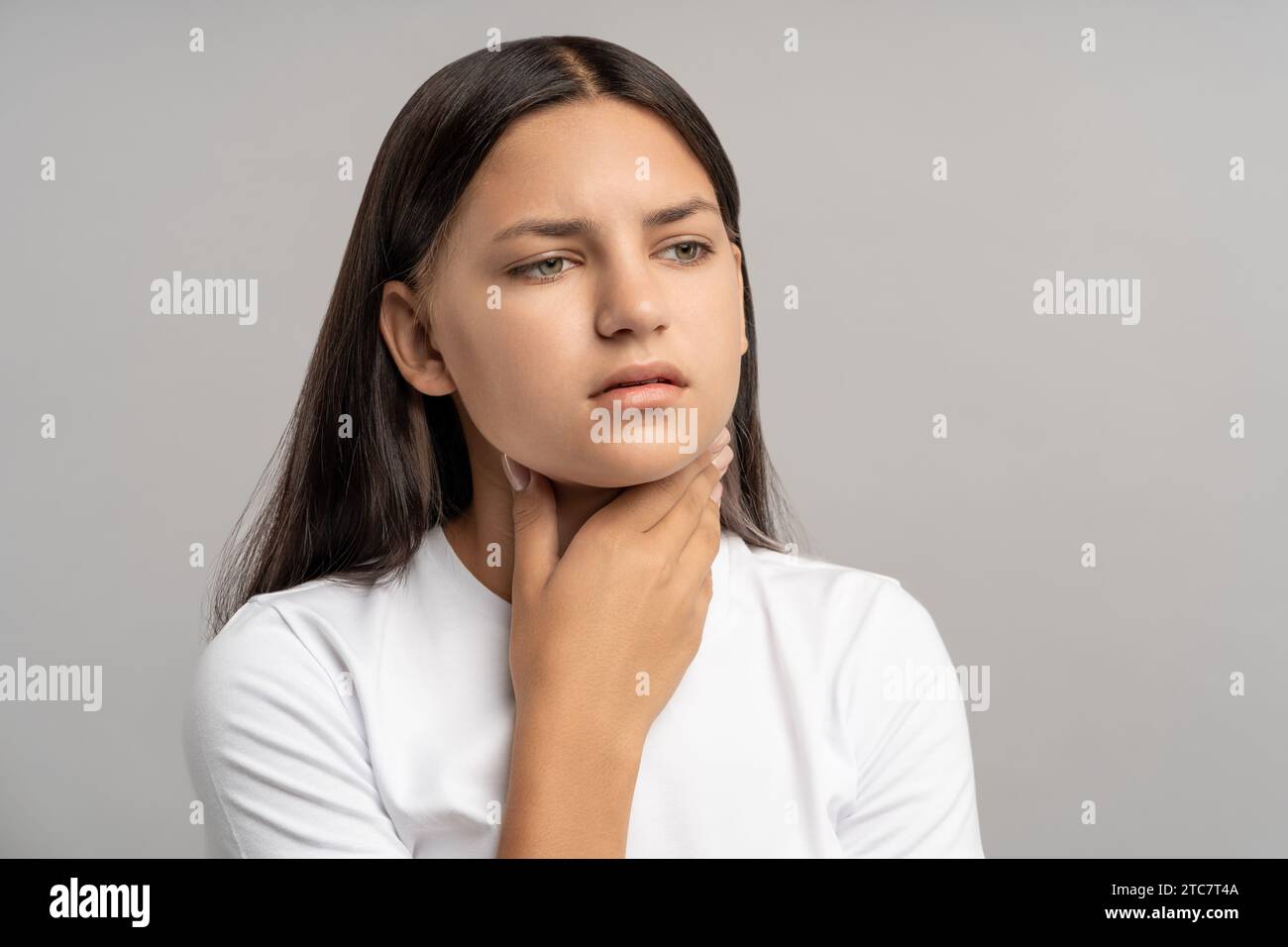Schoolgirl feeling sick, unwell, suffering from sore throat, having ...