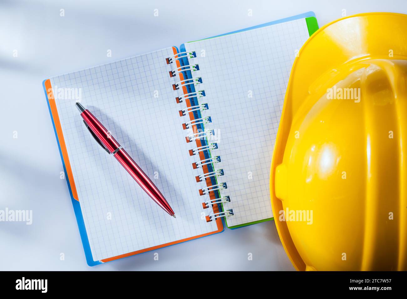 Building helmet notepad pen on white background Stock Photo - Alamy