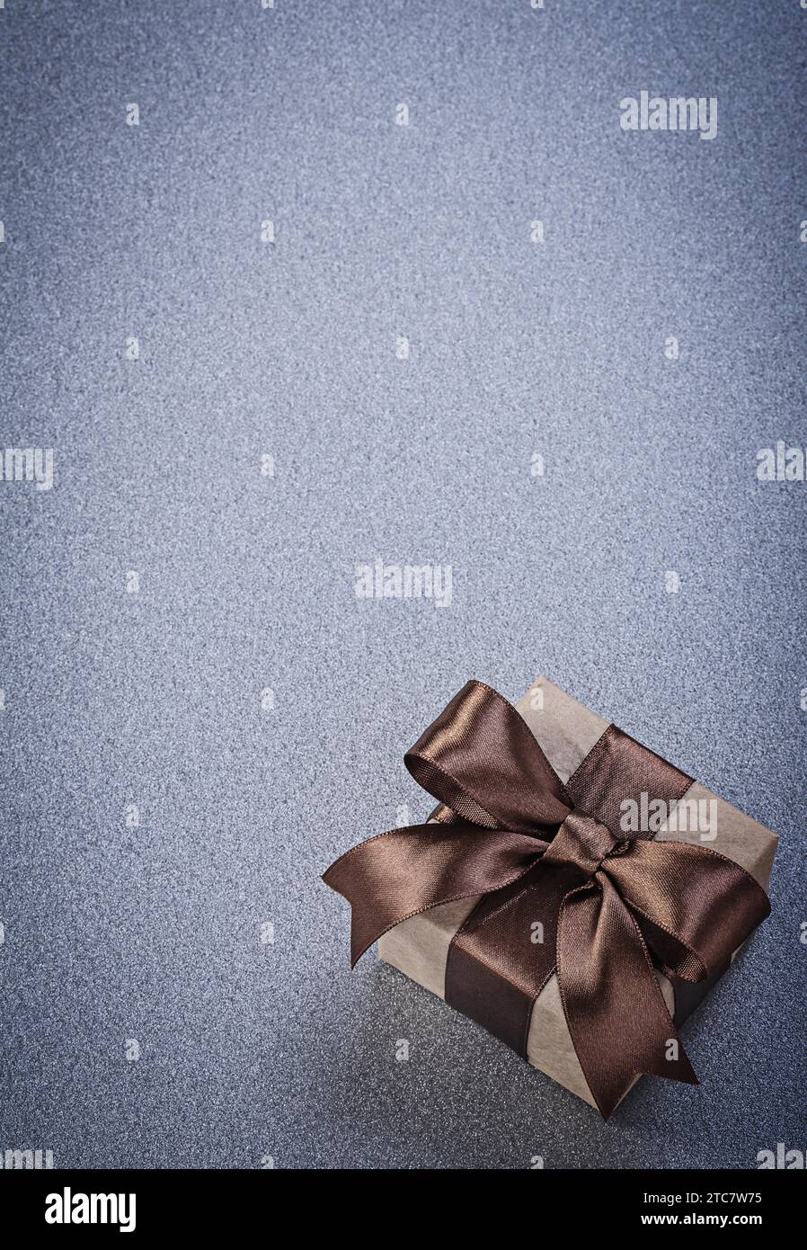 Boxed present in brown paper on grey background celebrations concept ...