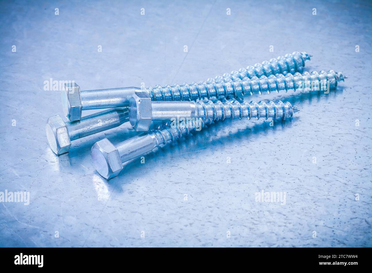 Steel threaded bolts on metallic background construction concept Stock ...