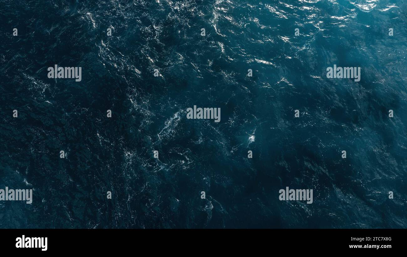 Aerial view of the dark blue ocean with textured water patterns and ...