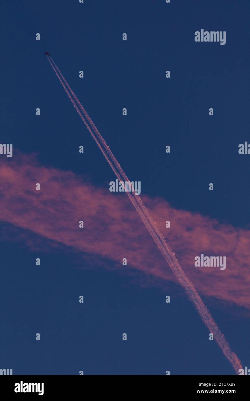 A beautiful image of plane's glowing, golden high altitude condensation ...