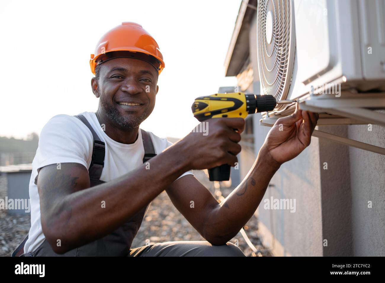 Technician repairing air conditioner using screwdriver hi-res stock ...