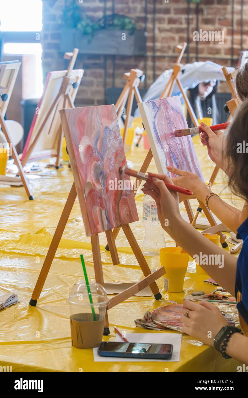 Woman paint brush canvas friends hi-res stock photography and images ...