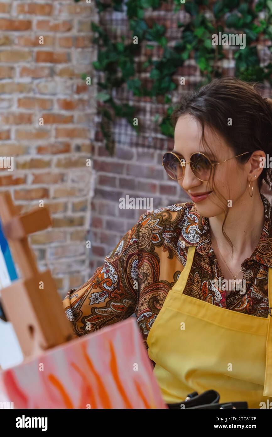 Woman paint brush canvas friends hi-res stock photography and images ...