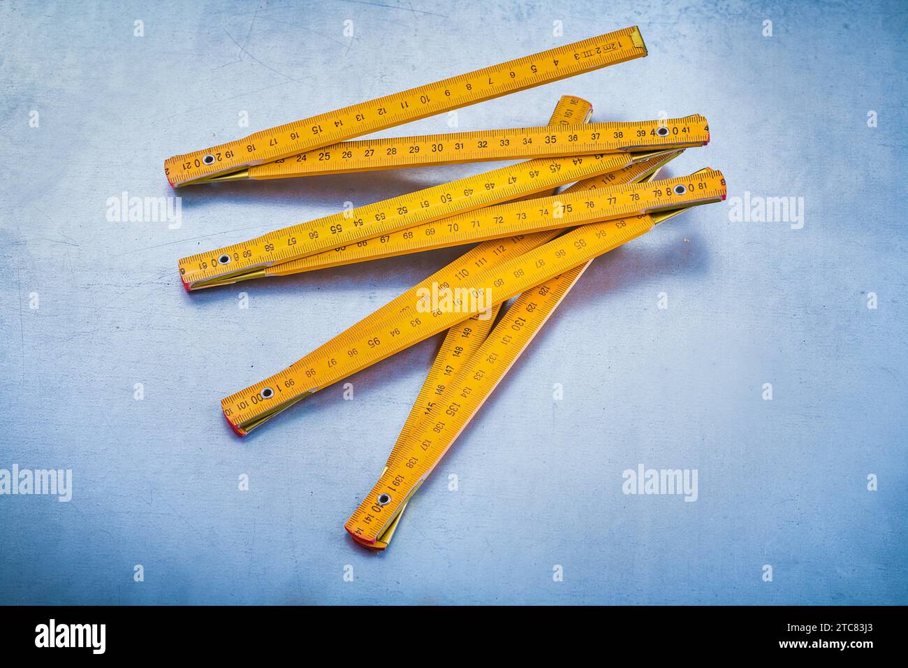 Wooden meter on metallic background vertical view construction concept ...