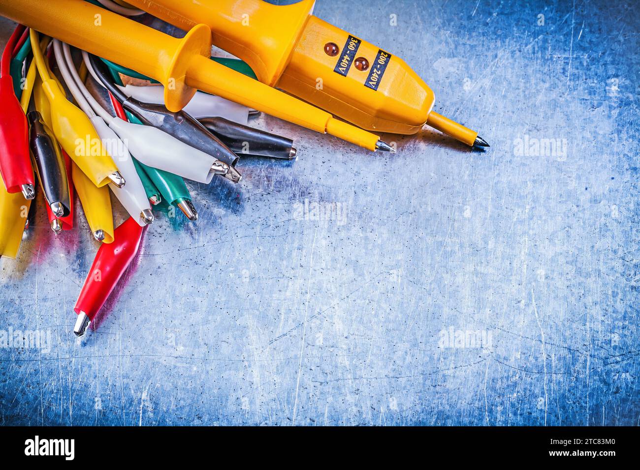 Yellow electrical tester crocodile cables set on metallic background ...