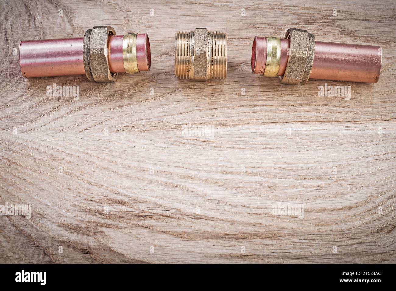 Copper water pipe threaded hose nipples on wooden board plumbing ...