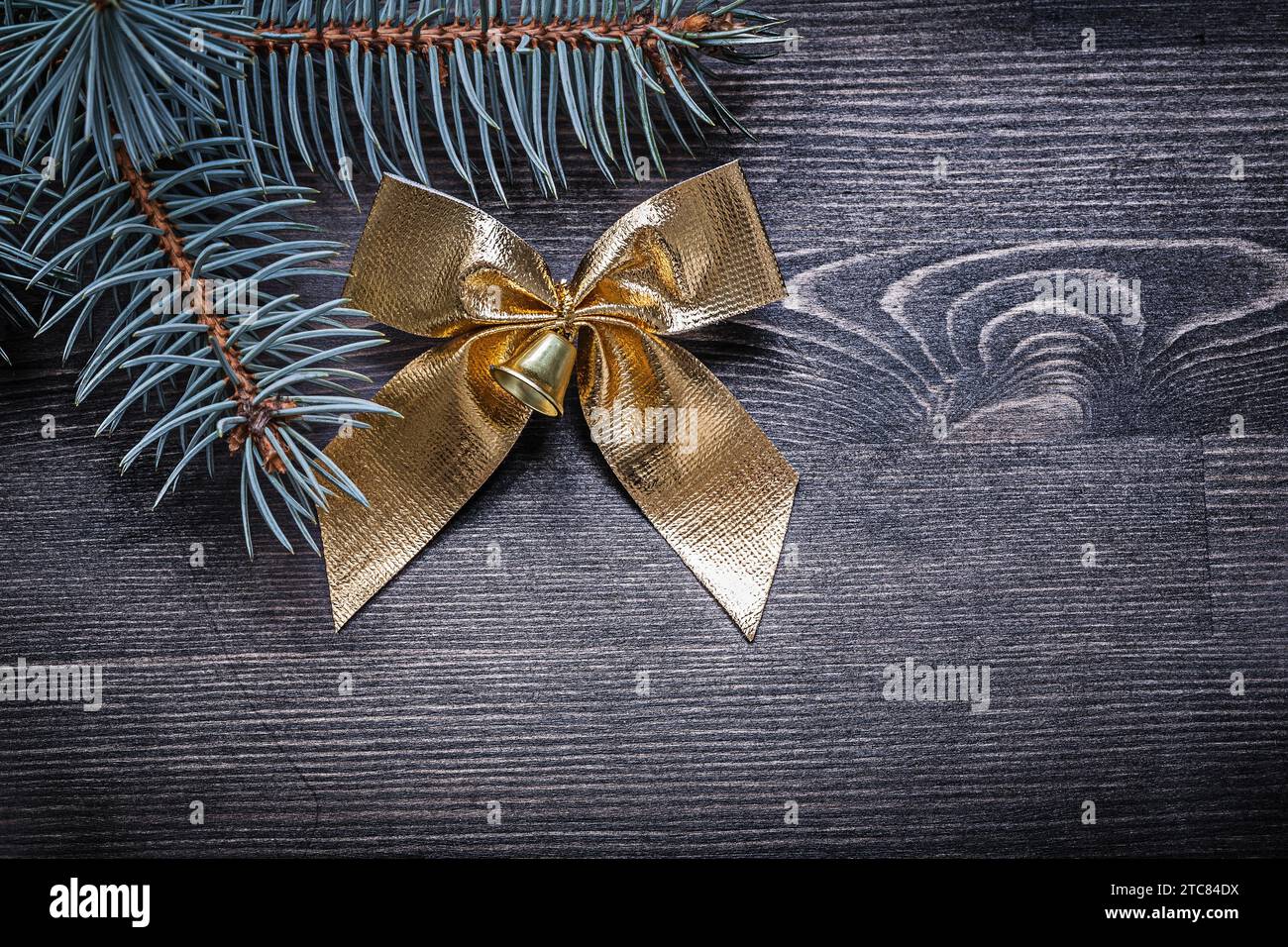 Christmas bow pine tree branch on wooden board holiday concept Stock ...