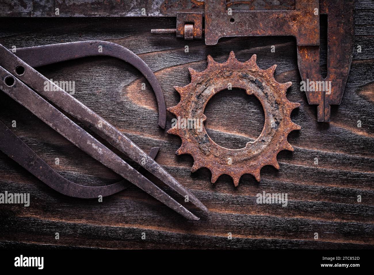 Rusted antique measuring calipers with cog- wheel on vintage dark ...